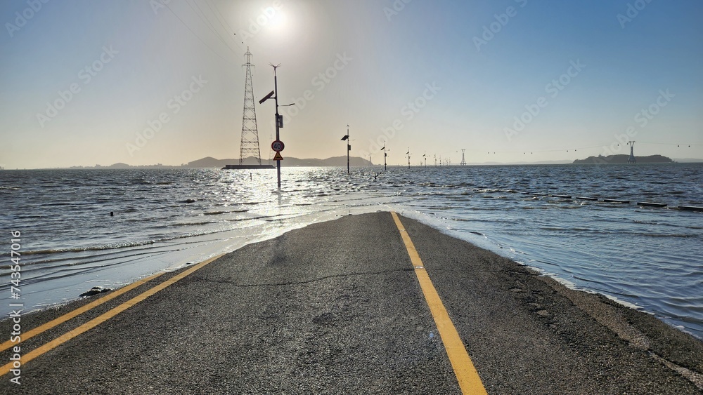 the view of the road submerged in the sea at high tide 스톡 사진 | Adobe Stock