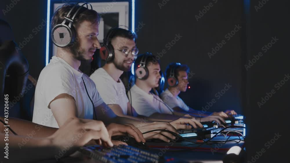 Gamers of team puts on headsets at PC computer club, cyber sport ...