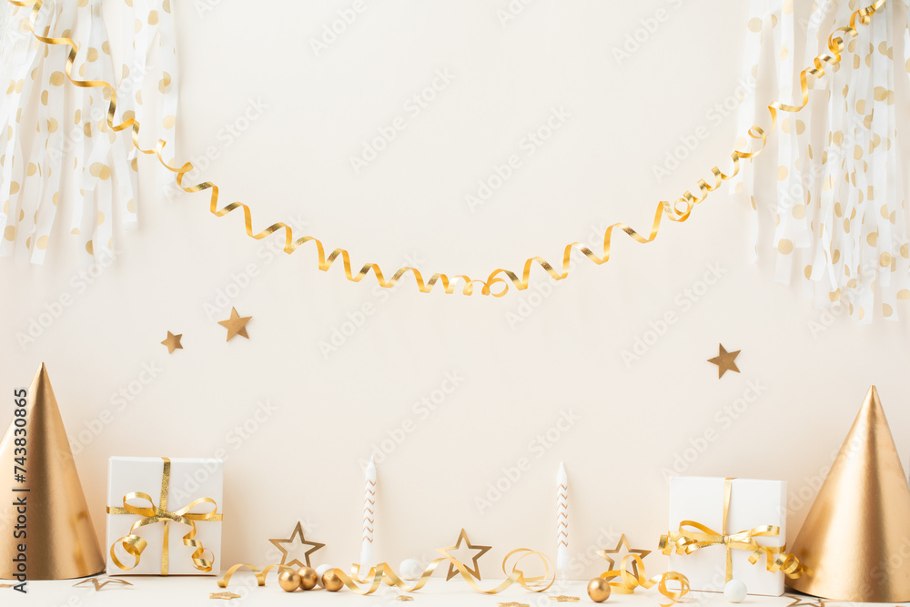 Birthday or party background with golden gift box, carnival cap and ...