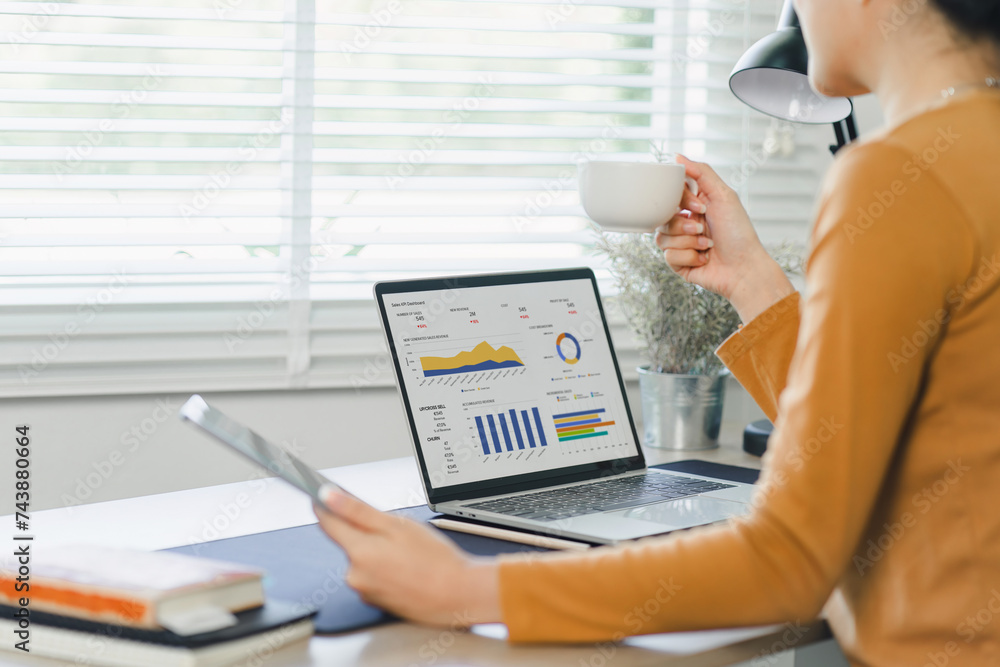 Female analyst analyzes KPI Business Analytics Data Dashboard ...