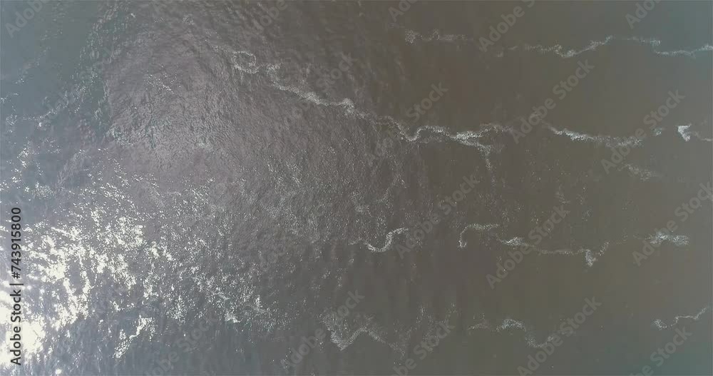 Water surface from above, ripples on the water. Glare on the water ...