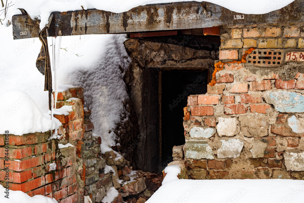 Broken brick wall of an old cellar covered with snow Stock Photo ...