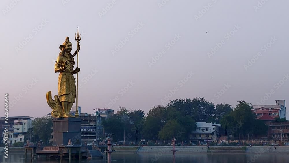 Enjoy a beautiful side view of the immense gilded Lord Shiva statue in ...