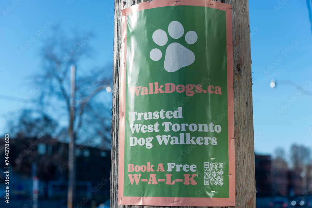 retro style paper bill or poster for WalkDogs stapled to a utility pole ...