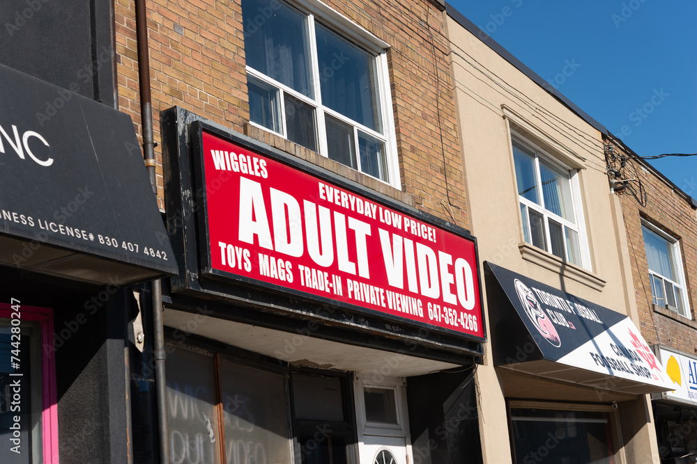 exterior building facade and sign of Wiggles Adult Video, an adult ...