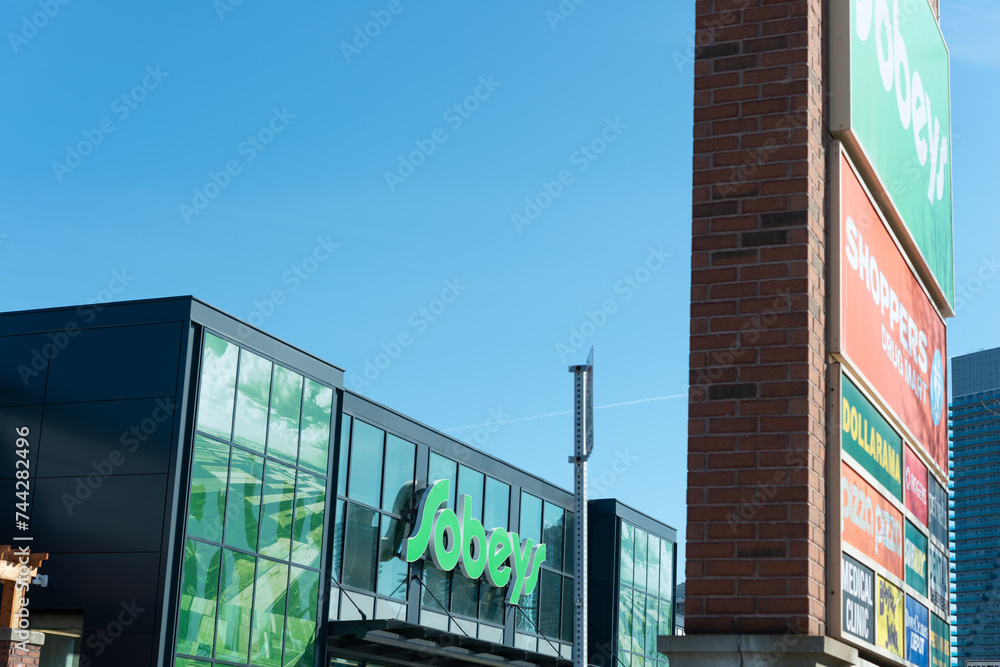 exterior building facade and pylon sign of Sobeys, a grocery store ...