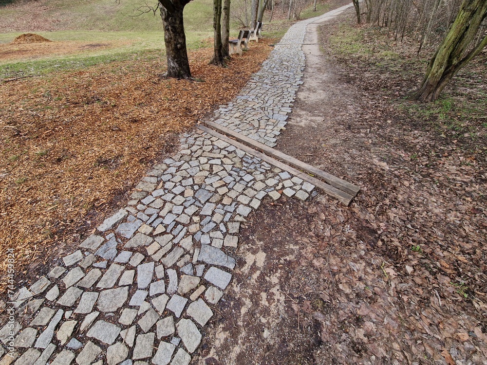 granite paving of irregular sections of chipped stone around a park ...