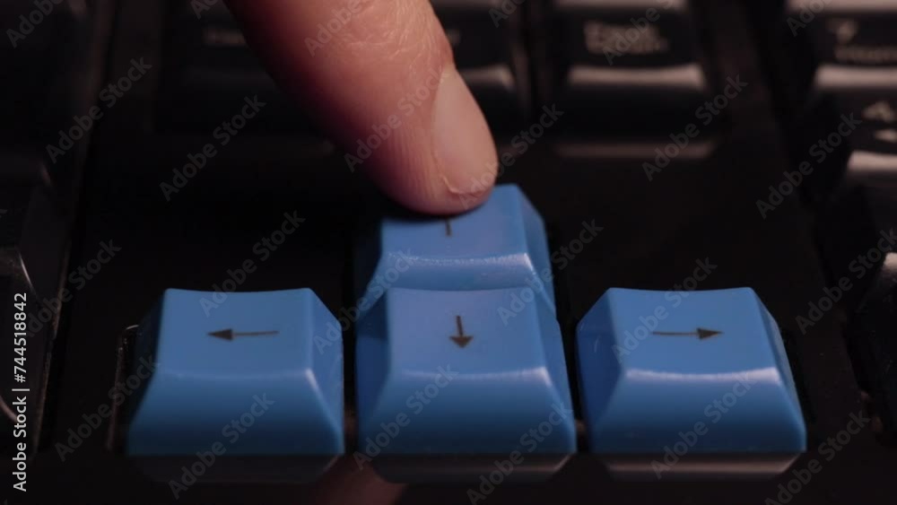 Close-up slow motion footage of a finger is pressing computer keys on ...