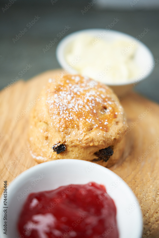 A beautiful gourmet scone served with tea and coffee, strawberry jam ...
