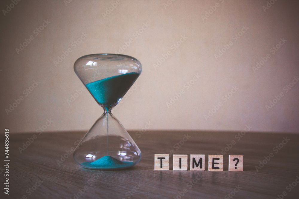 Word "time ?" alphabet on wooden cubes with hourglass. the word "time ...