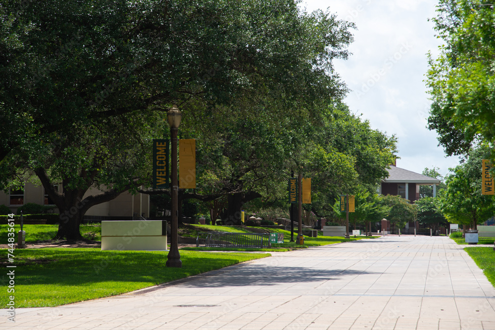 Large brick walkway with row of post light pole banners welcome Waco ...