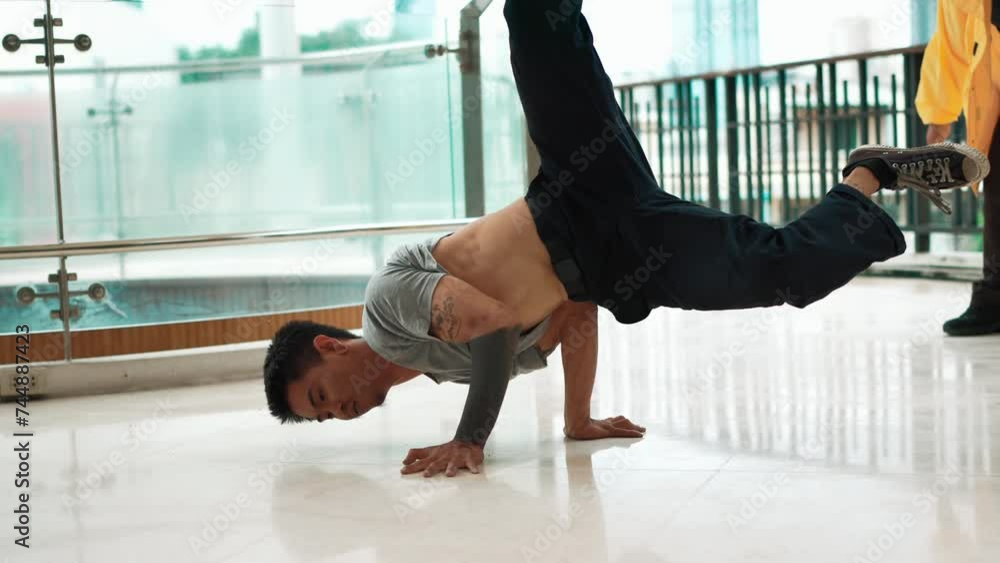 Hip-hop teenager group perform b-boy dance at mall corridor with city ...
