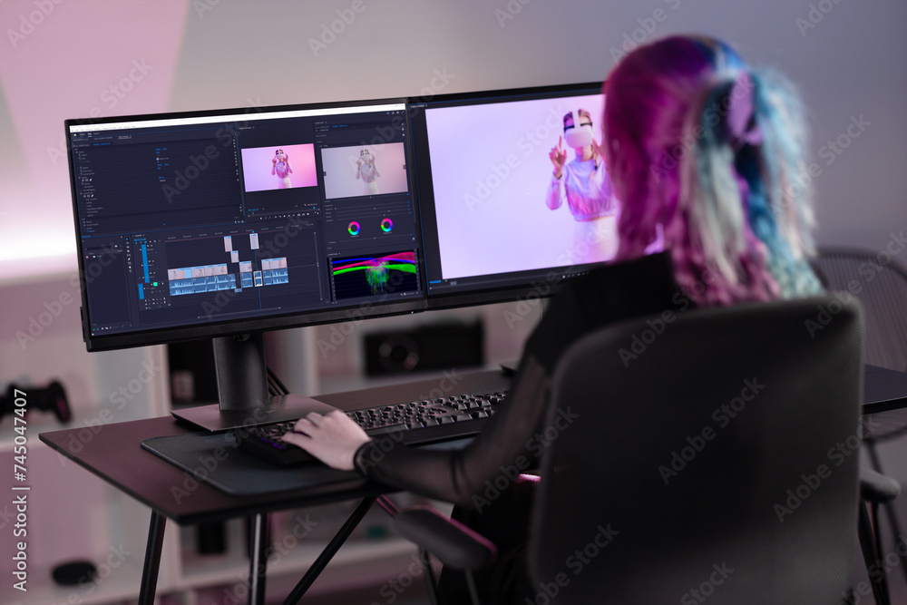 Professional female film editor editing video on his personal computer ...