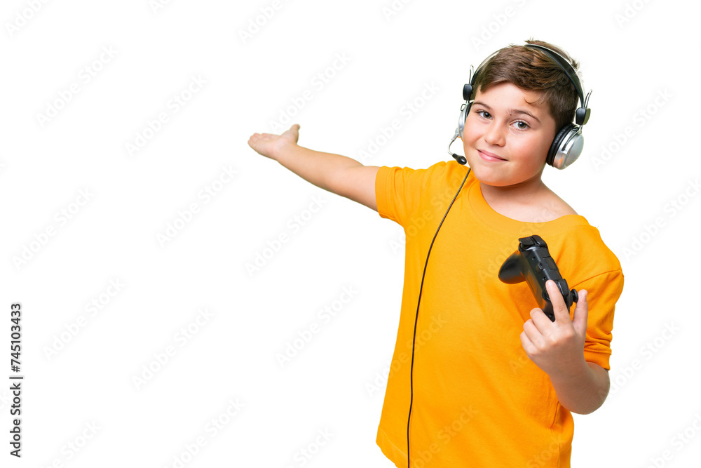 Little caucasian kid playing with a video game controller over isolated ...