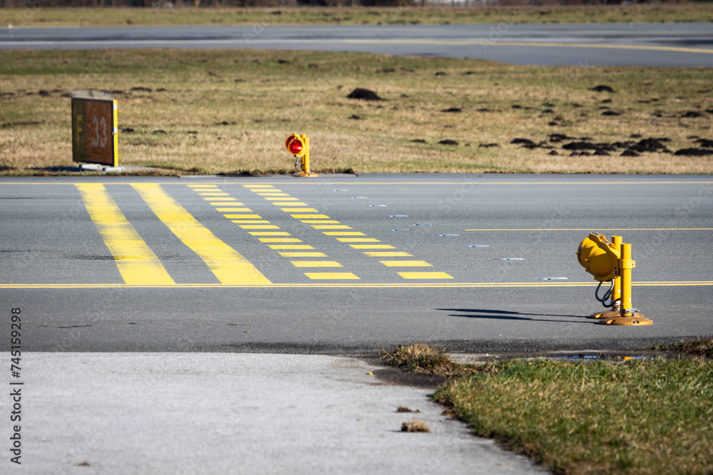 Stop bars on a airport taxiway at the holding point before entering the ...