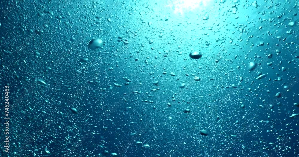 air bubbles slow underwater coming up scenery dark blue and sun shine ...