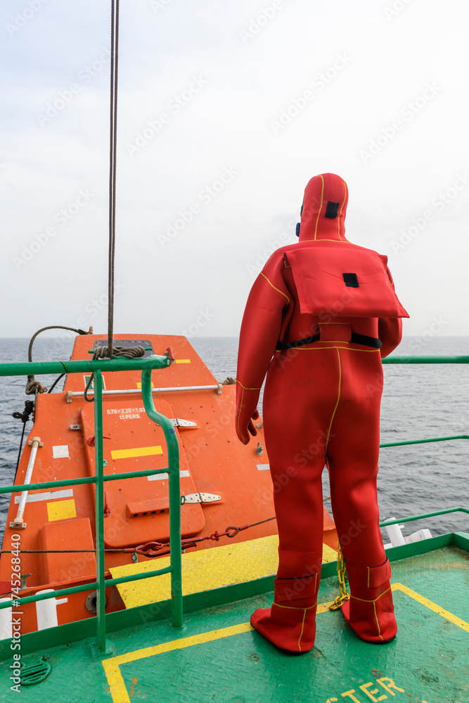 Seaman wearing Immersion Suit on Muster station. Abandon ship drill ...