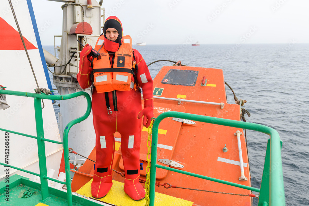 Seaman wearing Immersion Suit on Muster station. Abandon ship drill ...
