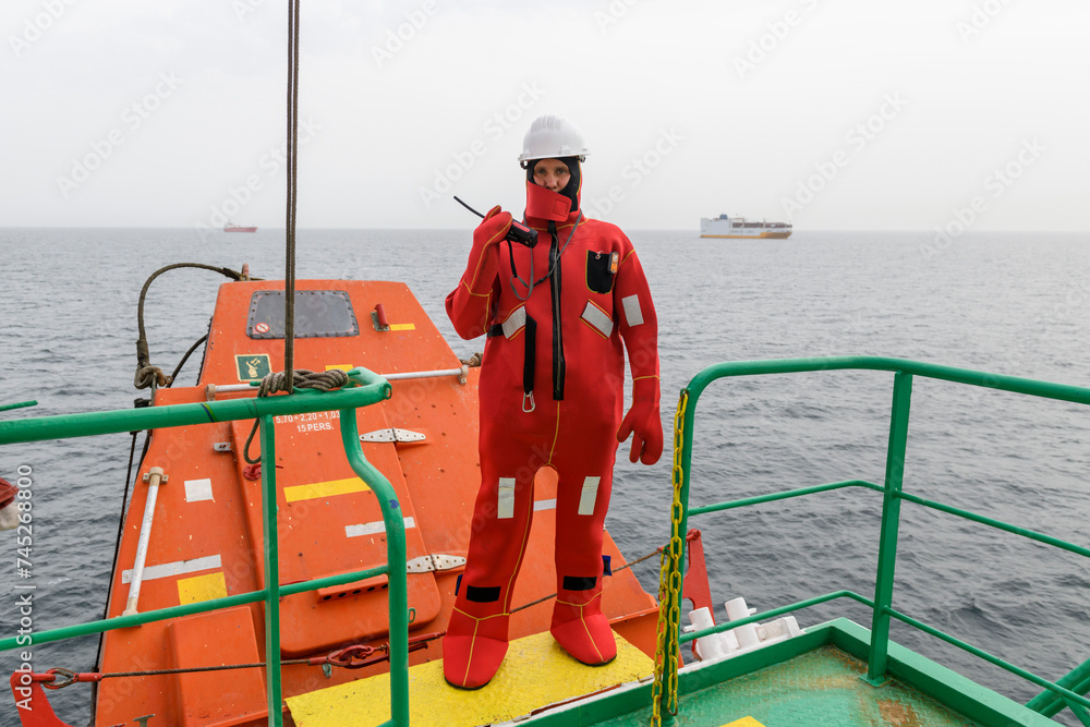 Seaman wearing Immersion Suit on Muster station. Abandon ship drill ...