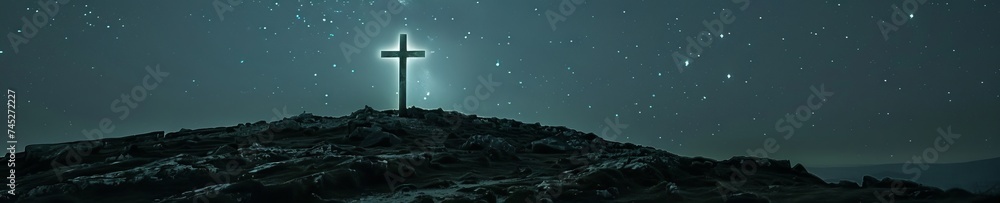 Nighttime on a mountain top a cross glowing bright illuminating a ...