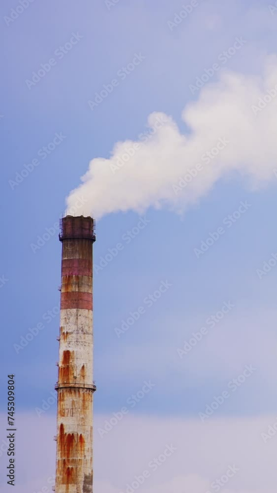 Two old rusty pipes from an industrial zone. High pipes producing white ...
