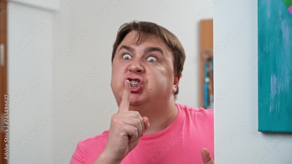 Angry, strict parent peeking out from behind wall puts hands to lips ...