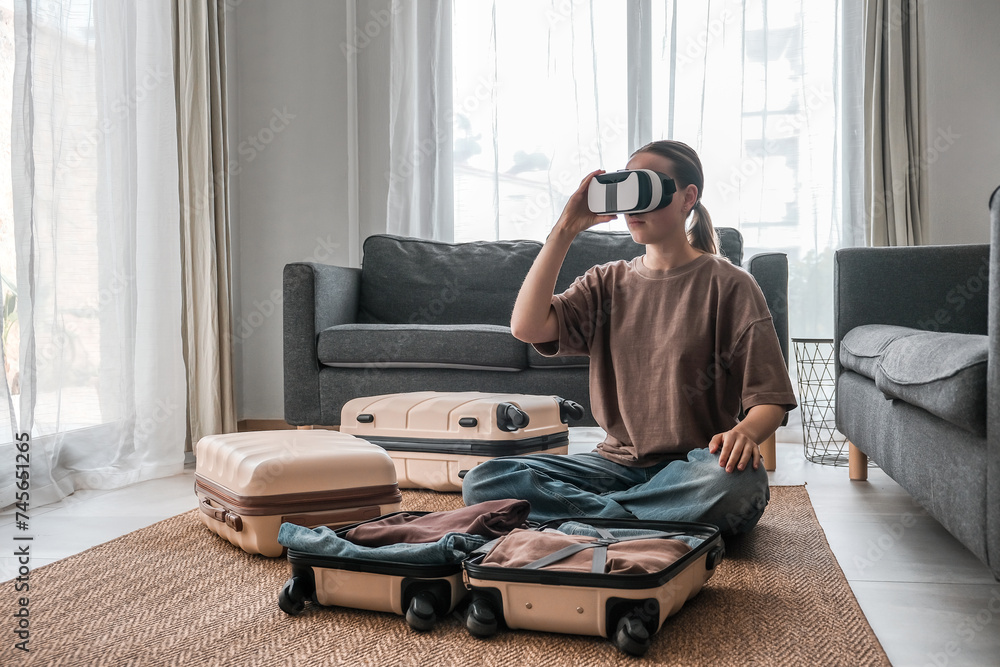 Travel,woman packing luggage in suitcase and travel in VR glasses ...
