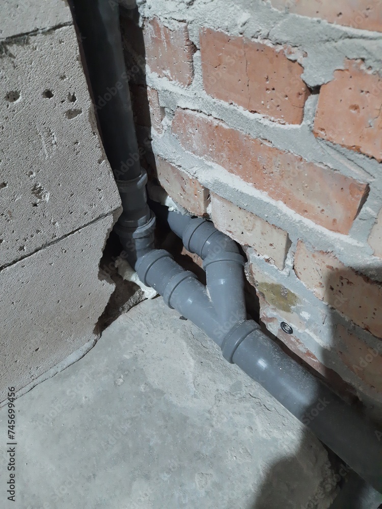 Installation of sewer pipes in the walls. Stock Photo | Adobe Stock