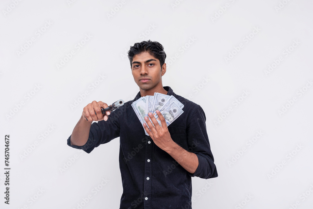 A cocky young indian man pointing a gun recklessly while flaunting some ... A cocky young indian man pointing a gun recklessly while flaunting some ...