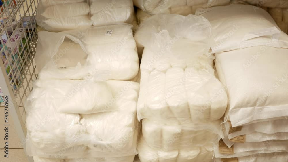Sacks of sugar and flour on pallets lie in the warehouse shop. Import ...