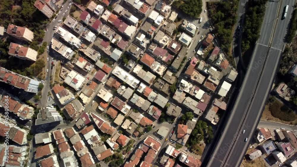 An urban landscape filled with buildings, houses, and highways, seen ...