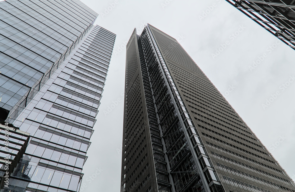 tall skyscraper buildings looking up with overcast dark cloudy sky in ...