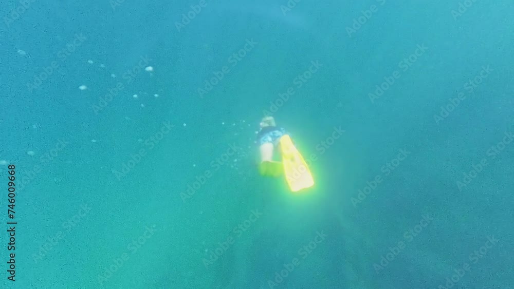 Scuba diver with yellow fins explores the tranquil underwater world ...