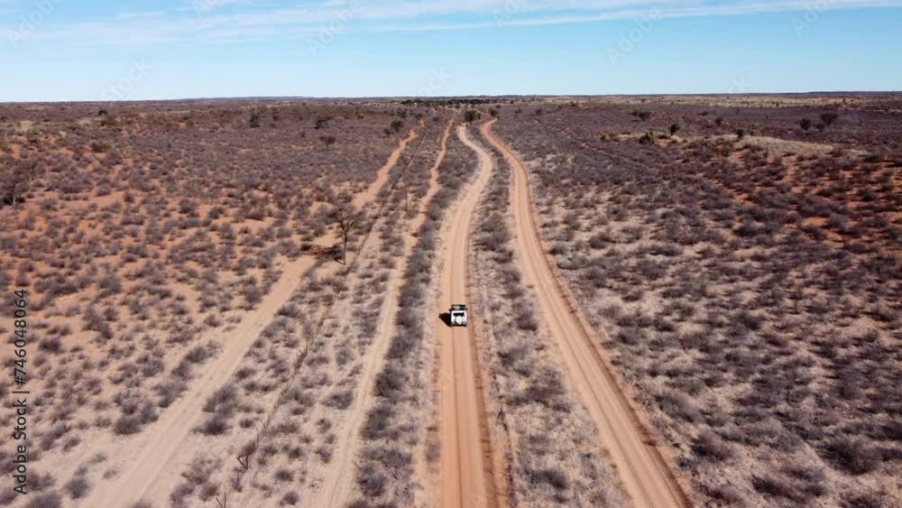 Drone flight over Kalahari. Drone follows a tiny little car driving ...