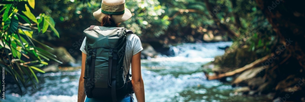 Female adventurer exploring a lush forest - A solo traveler with a ...