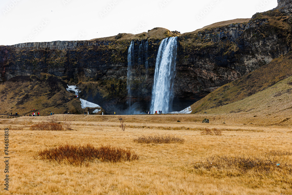 Spectacular waterfall in iceland with stream falling off hills ...