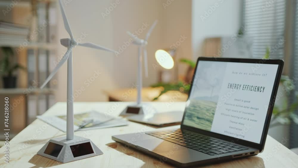Wind turbine model and laptop with presentation about energy efficiency ...