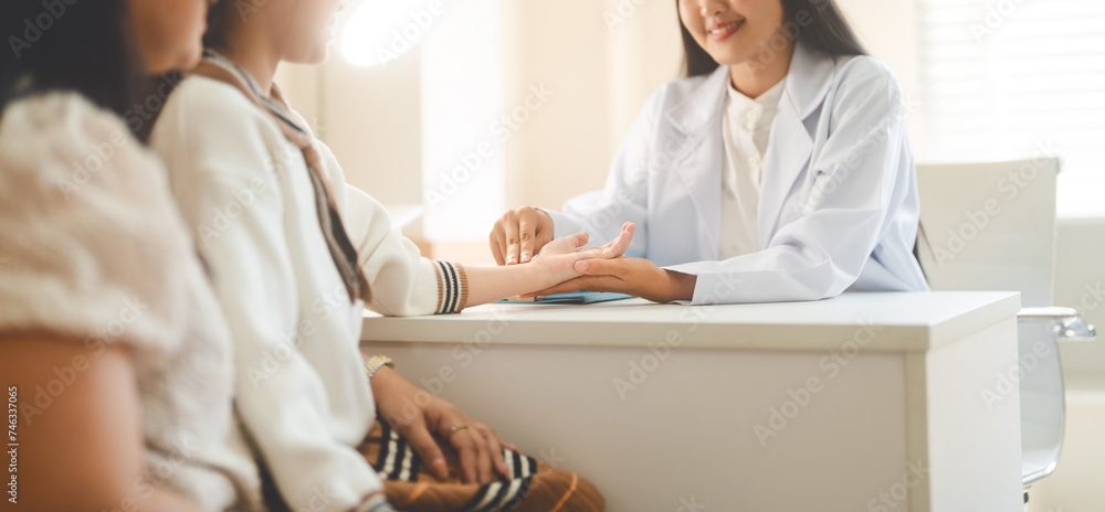 Asian doctor woman physical therapy arm check little girl health care ...