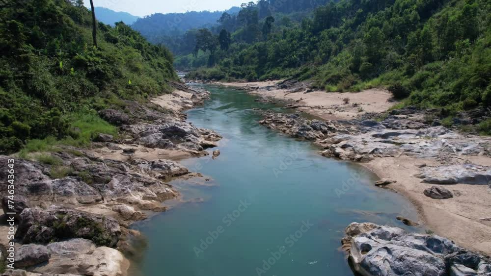Pristine river flowing through the rugged terrain of the Annamite Range ...