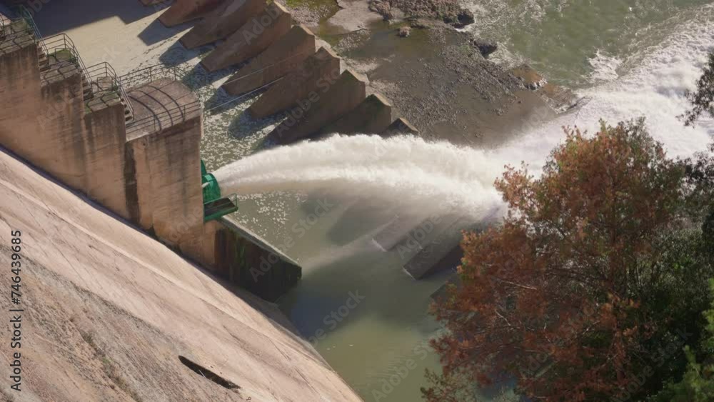 Hydroelectric dam Floodgate with flowing water through gate. Water ...