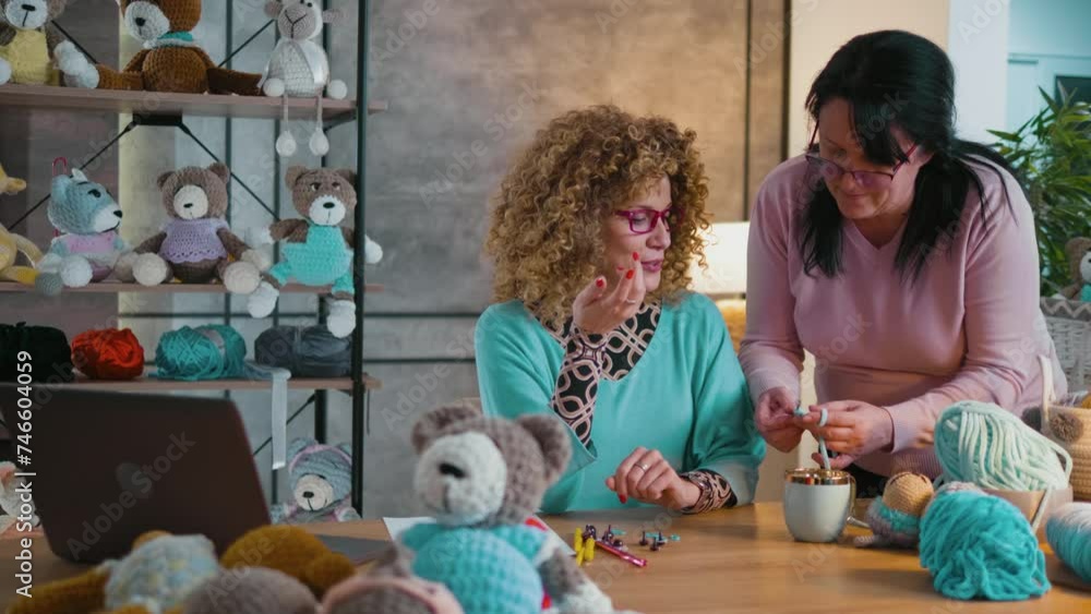 Elderly woman mother teaches her adult daughter how to crochet, two ...