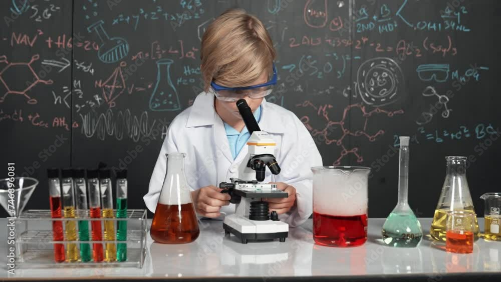 Vidéo Stock Smart boy using microscope analysis sample at science ...