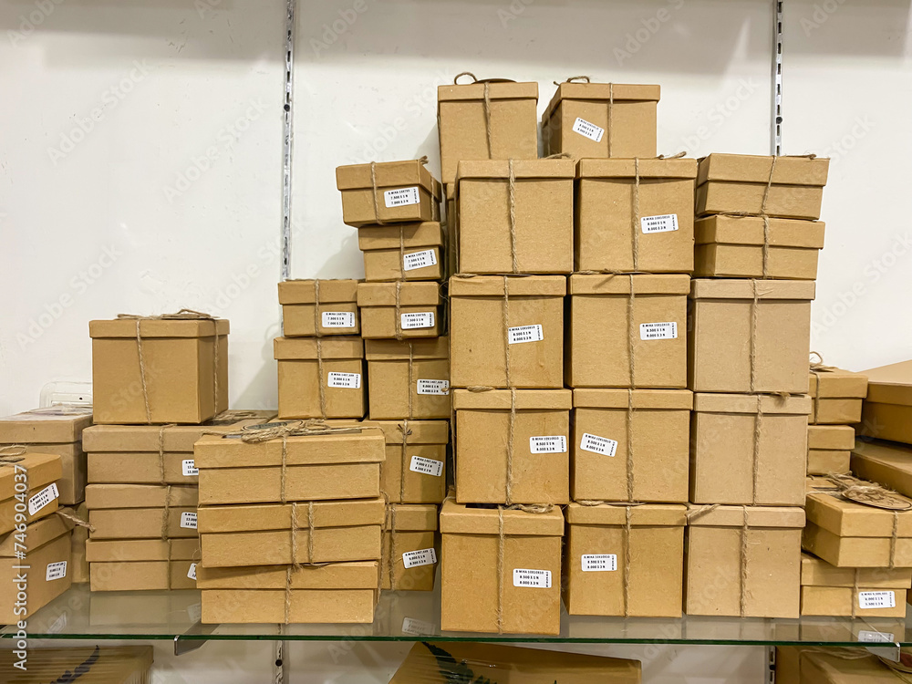 Stack of various cardboard boxes on a hanging rack in a packaging shop ...