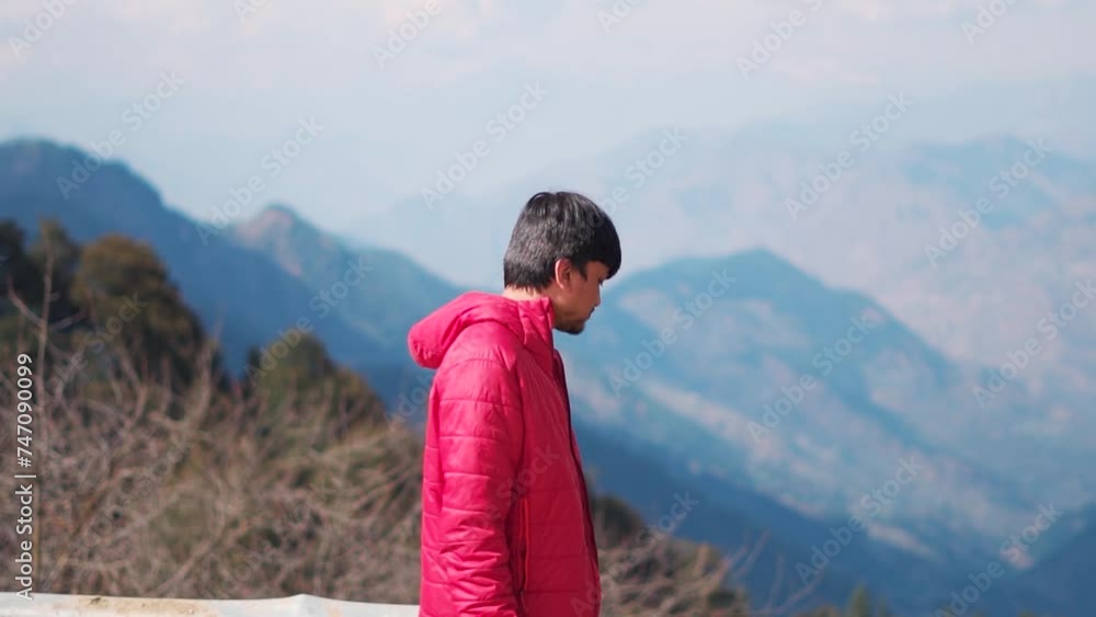 Video „Indian man walking in front of mountain ranges seen from top of ...