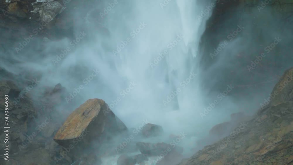 Close up shot of powerful stream of Sissu waterfall falling on the rock ...