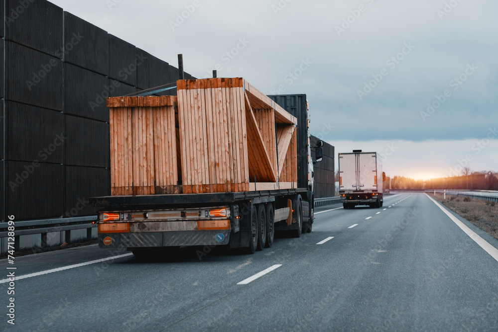 Transportation of timber wooden construction. Cargo for wood factories ...