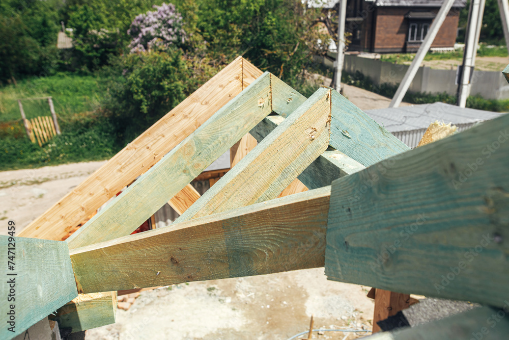 Unfinished roof trusses, view in attic with rafters and beams against ...
