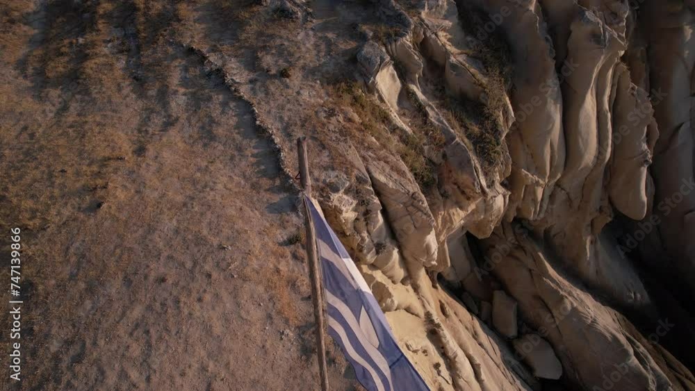 National Flag of Greece Waving on Pole on Top of Cliff Above Aegean Sea ...