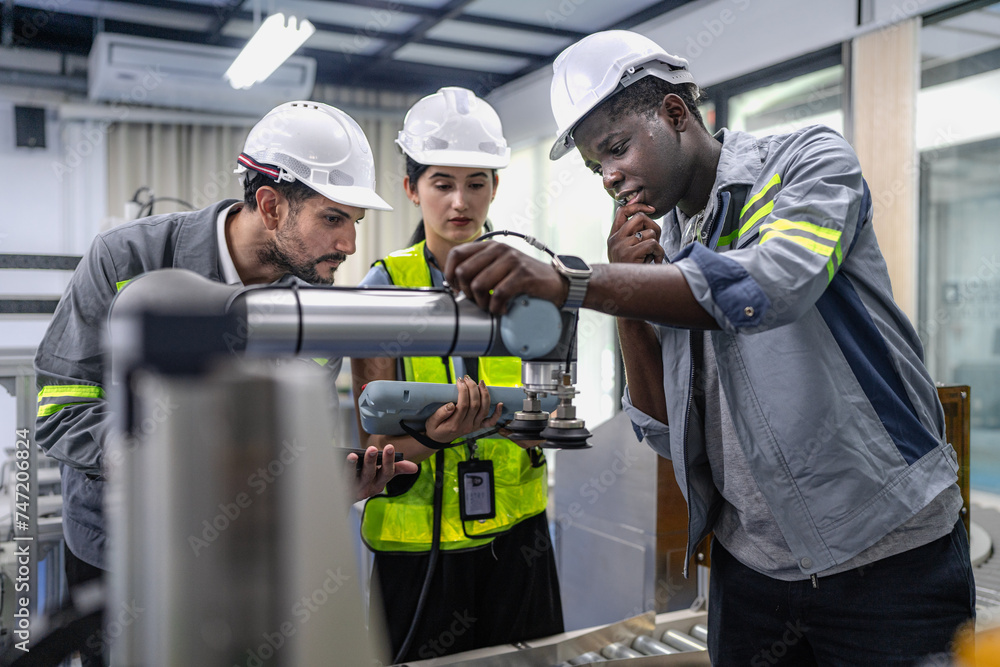 Group of diverse people working on robot programming in robotic and ...