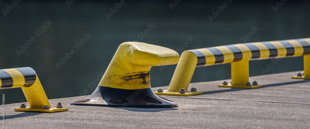 PORT QUAY - Yellow bollard for mooring ships Stock Photo | Adobe Stock